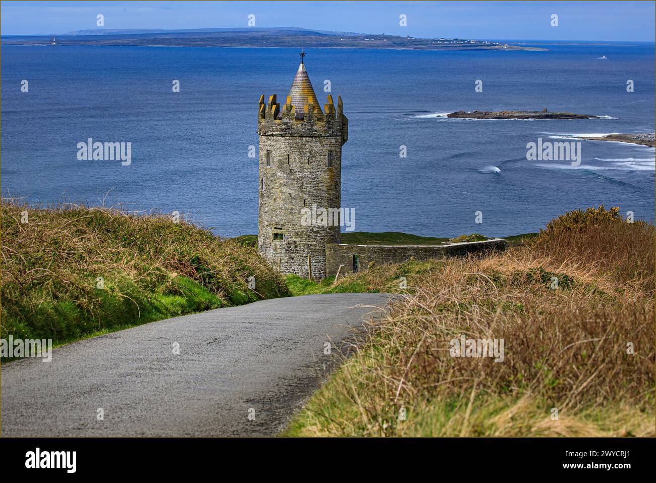 Tall stone tower on the edge of the Atlantic Ocean with the Aran ...