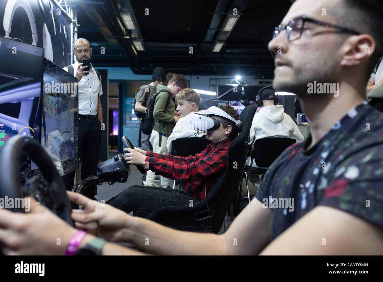 Ljubljana, Slovenia. 5th Apr, 2024. Visitors play racing games during ...