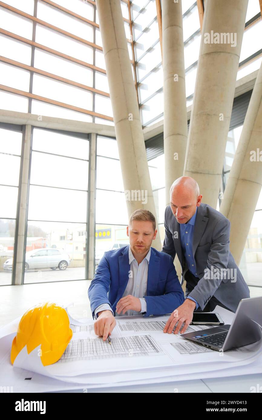 Architects looking at blueprints Stock Photo - Alamy