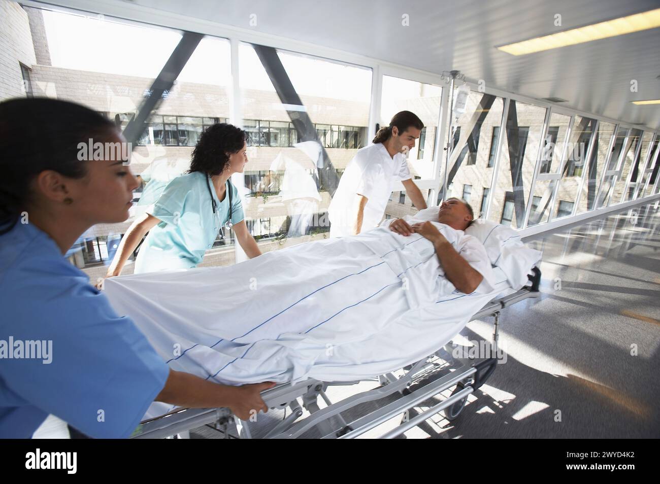 Nurses carrying patient Stock Photo - Alamy