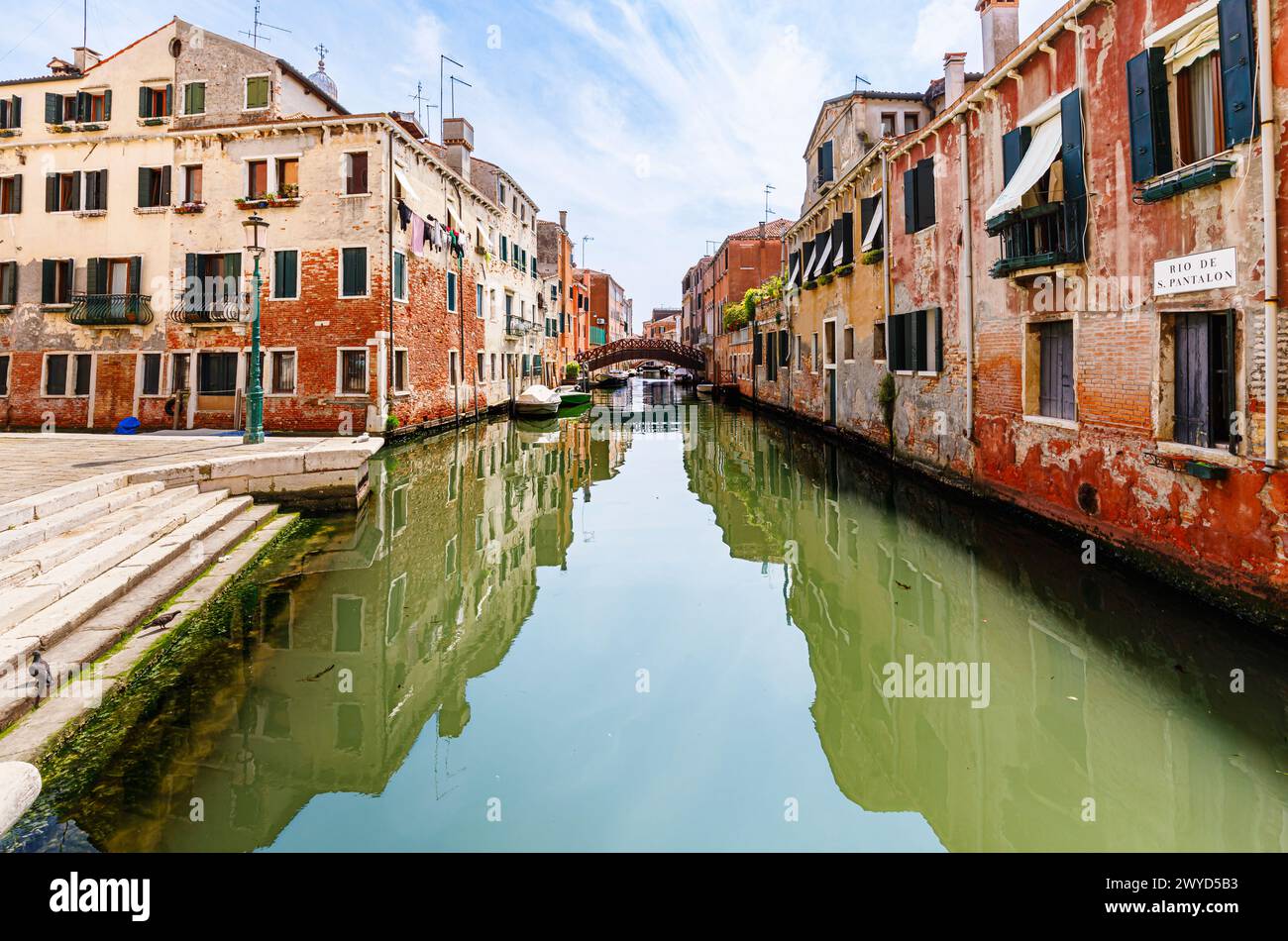 Crumbling buildings and reflections in the Rio De San Pantalon canal ...