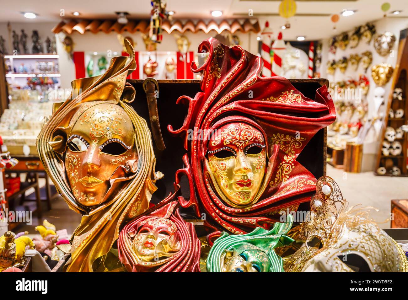 Typical colourful carnival masks for tourist souvenirs on display in a shop window in San Marco ...