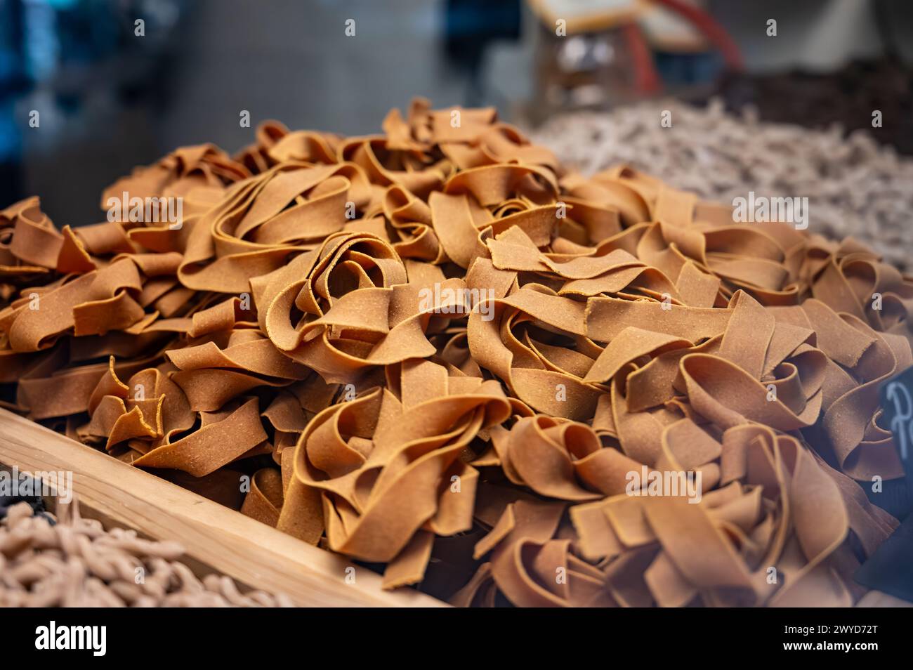 Italian food, dried handmade colorful pasta pappardelle with red ...