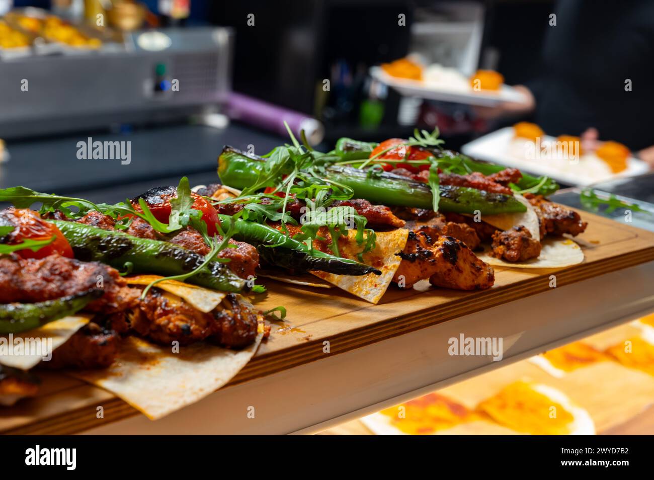 Wooden plate with Turkish mixed grill meat, chicken wings, lamb, beef ...