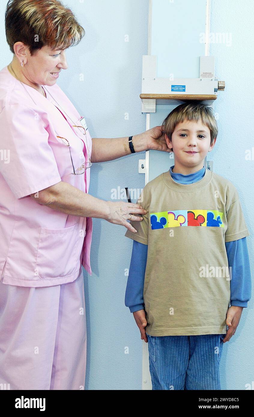 Nurse measuring 6 year old boy at pediatrics section of hospital Stock ...