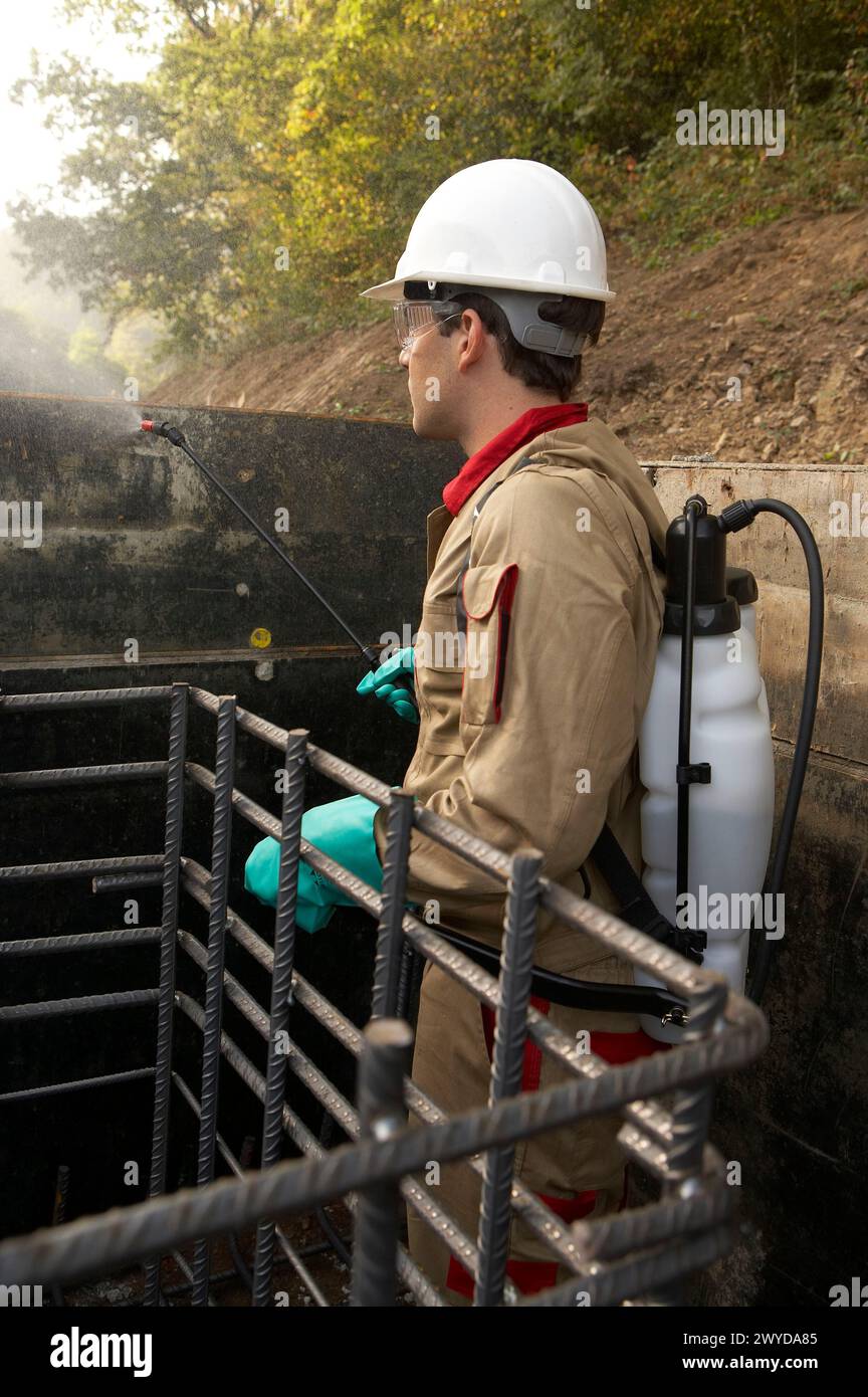 Applying form release agents with sprayer, concrete formworks Stock ...