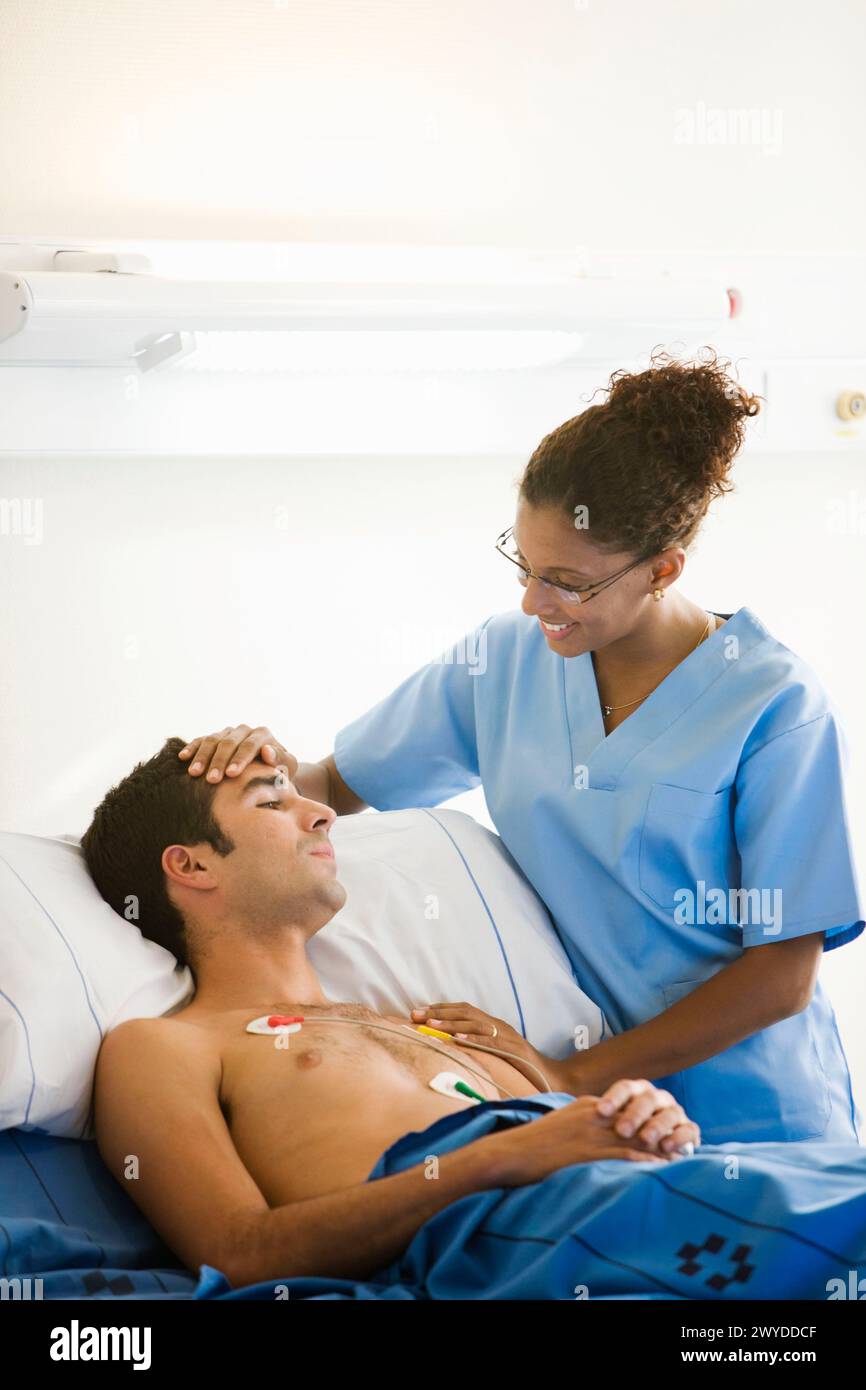 Nurse touching forehead patient hi-res stock photography and images - Alamy