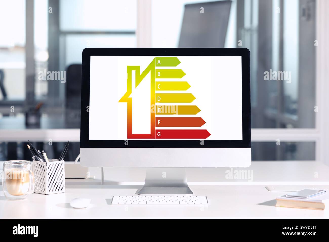 Energy efficiency rating on display. Workplace with modern computer ...