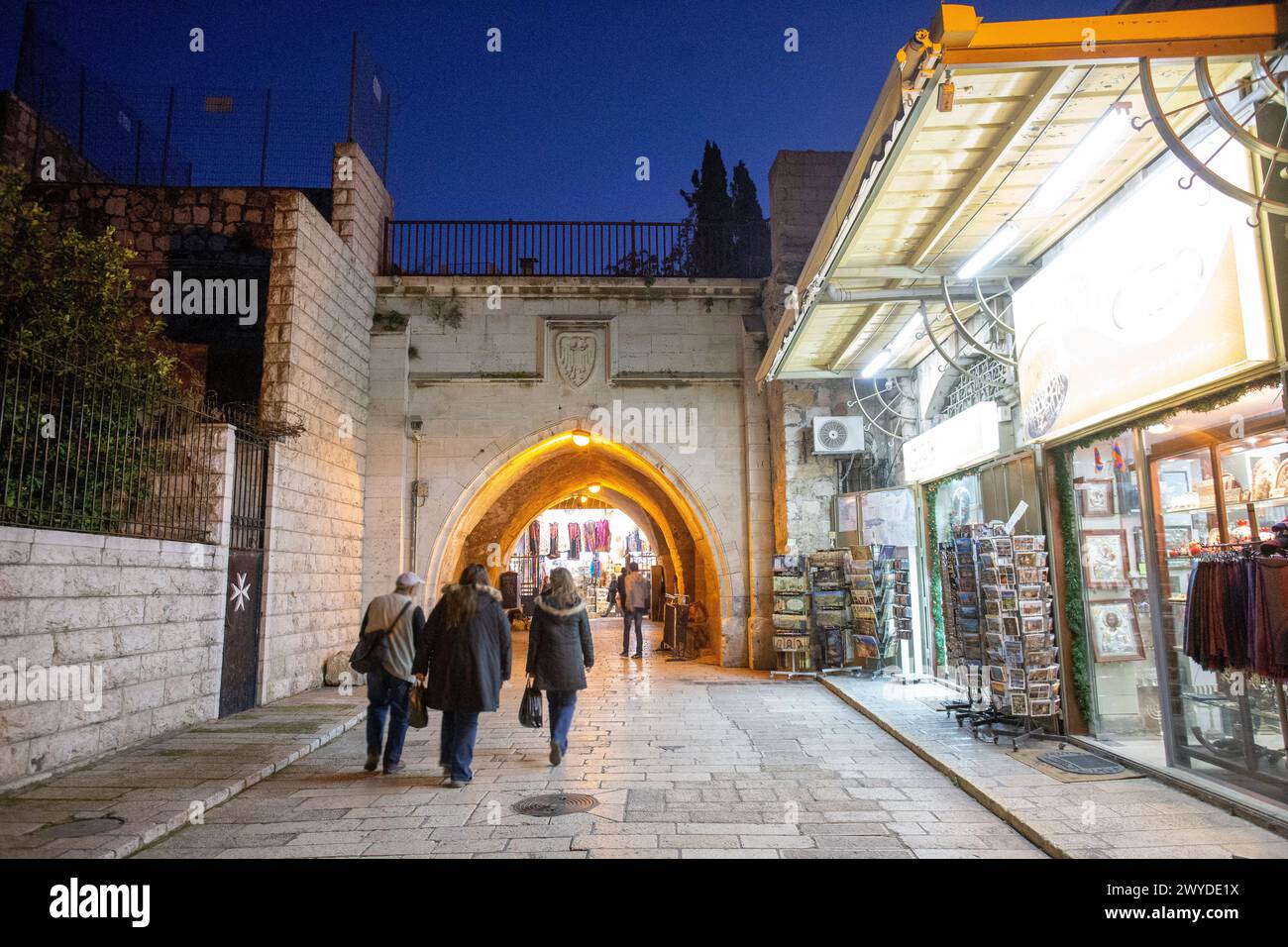 People walking on street inside Jerusalem Old city at night with open ...