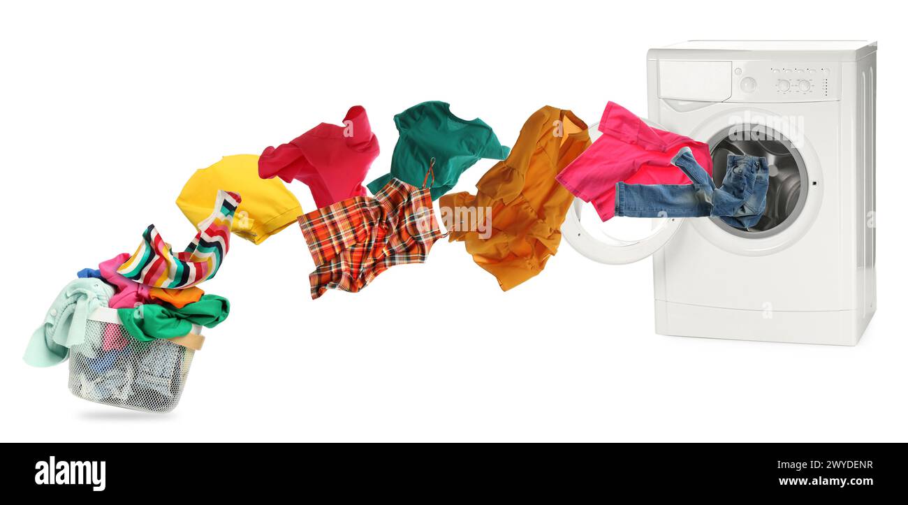 Clothes flying from laundry basket into washing machine on white ...