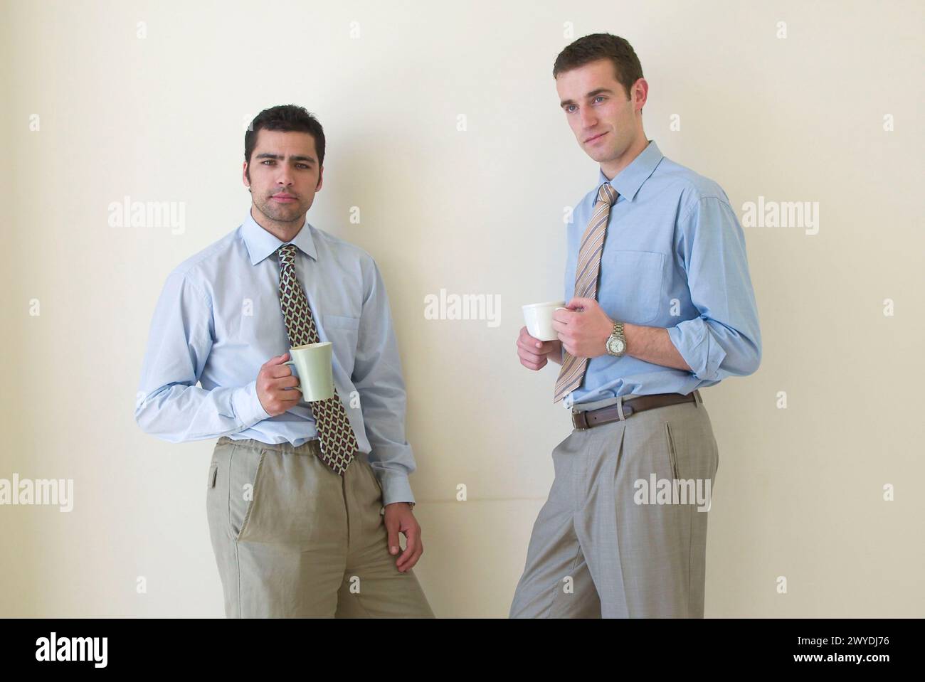 Businessman standing drinking coffee colleagues hi-res stock ...