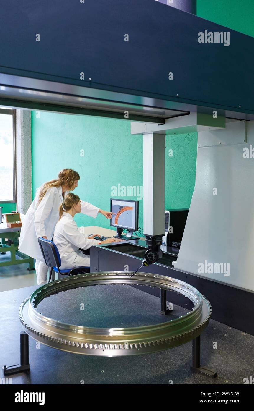 Technicians inspecting aircraft component. Measurement of a piece in ...