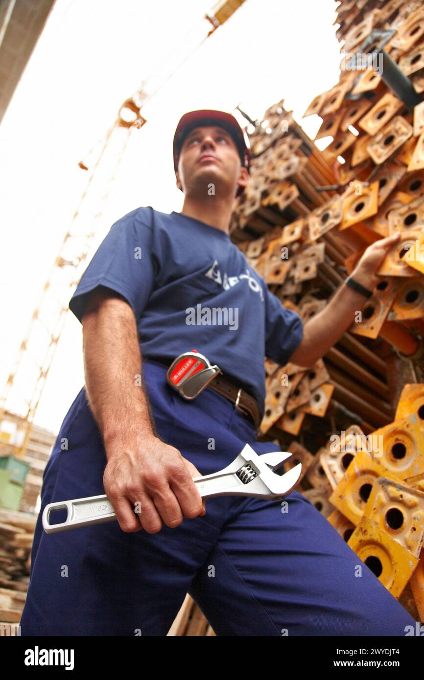 Worker holding adjustable spanner in a construction site Stock Photo ...