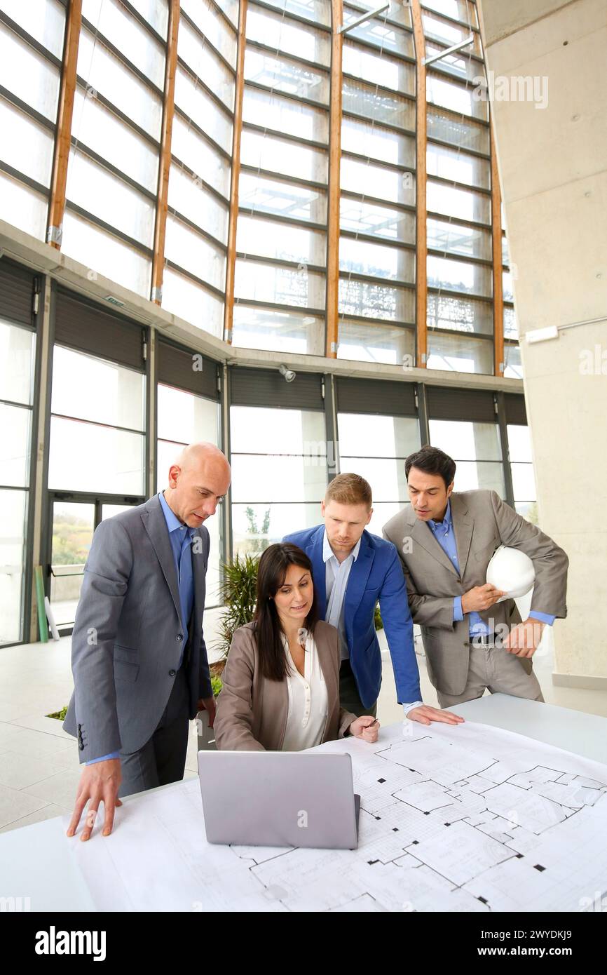 Architects looking at blueprints Stock Photo - Alamy