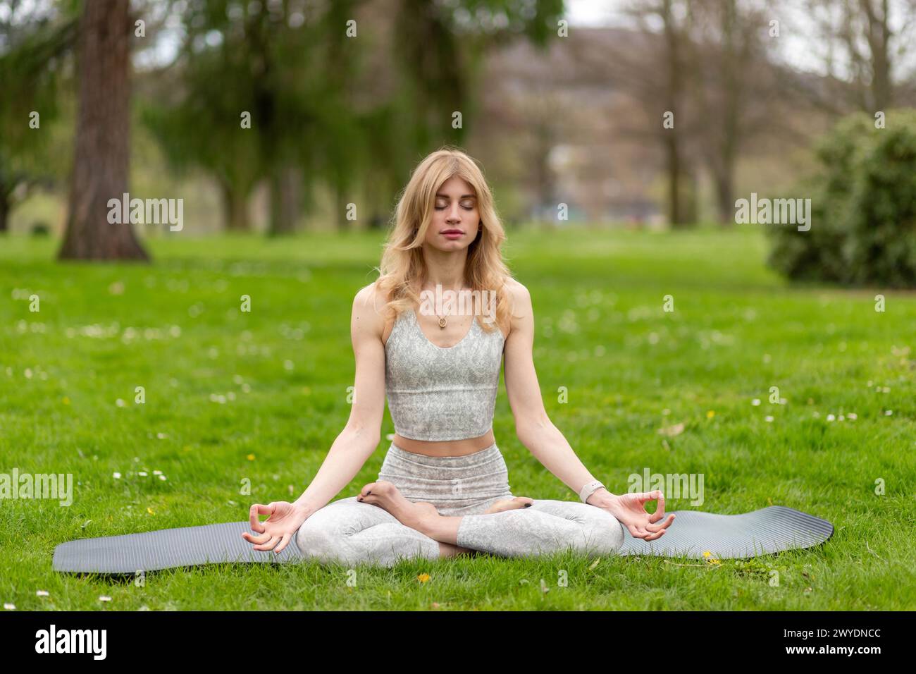 Woman meditating in lotus pose hi-res stock photography and images - Alamy