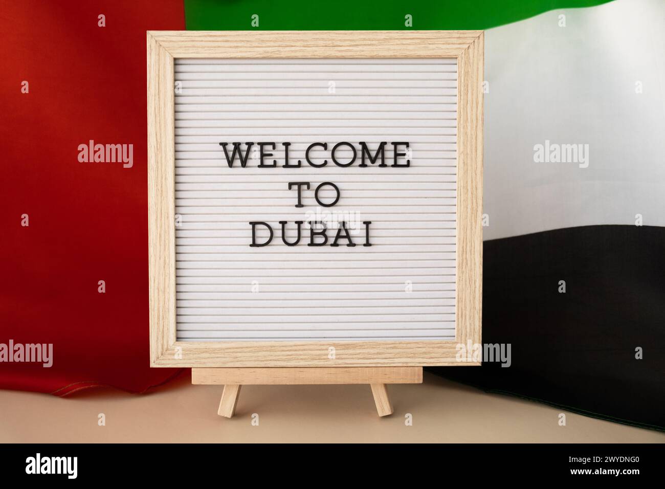 Message text WELCOME TO DUBAI on background of waving UAE flag made ...