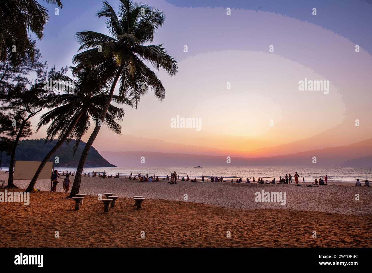 Awe view on beach with tourists and locals in town (village) in Goa (or ...