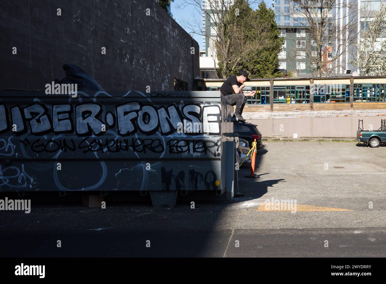Seattle, USA. 19th Mar, 2024. A man sitting on a garbage can in ...