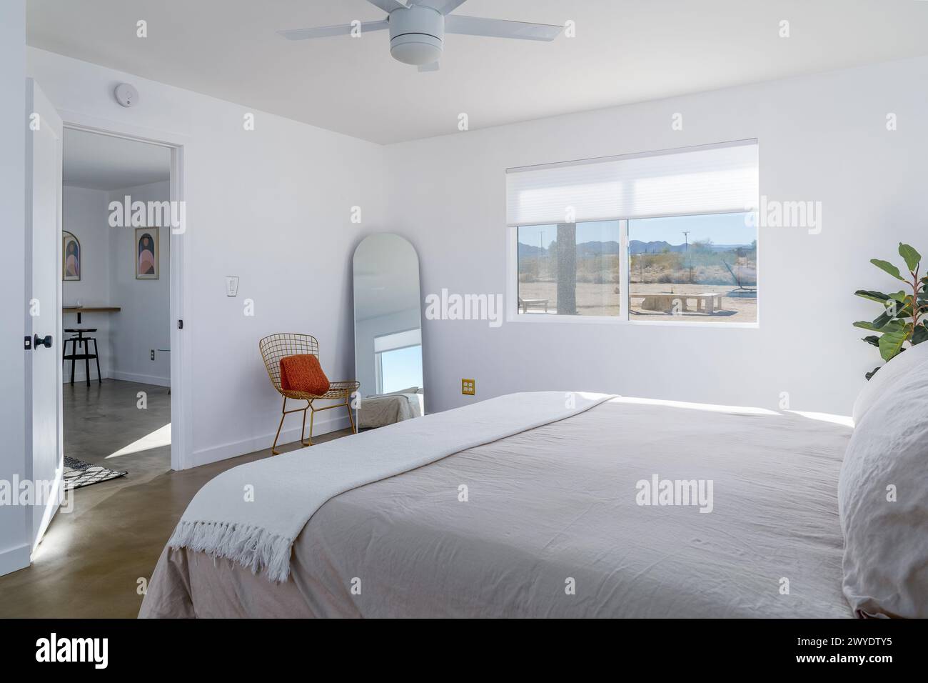 Modern bohemian desert home white bedroom with bed, throw blanket ...