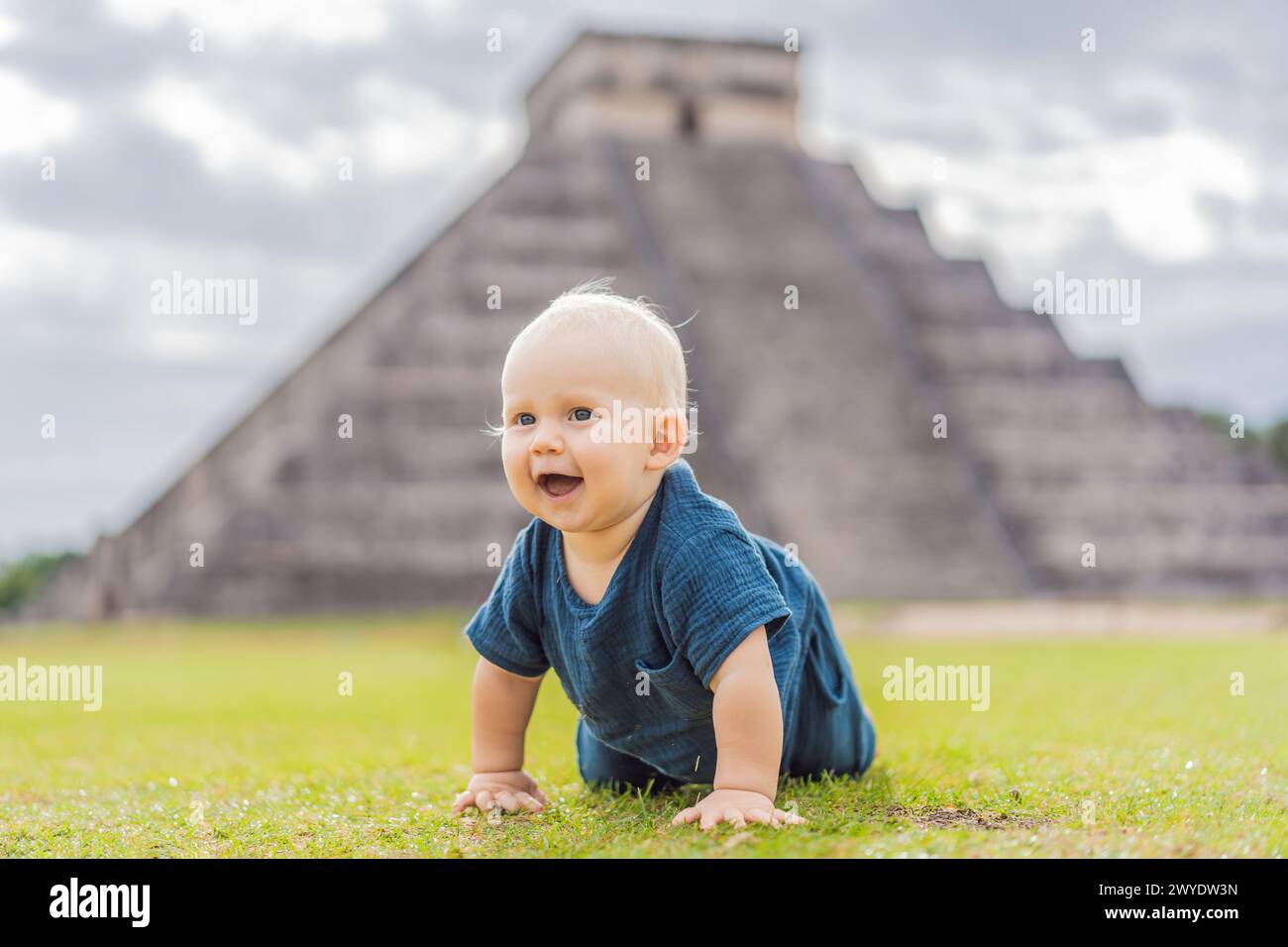 Baby traveler, tourists observing the old pyramid and temple of the ...