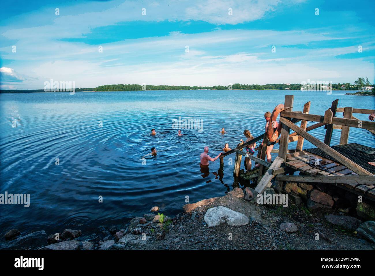 06-22-2022 Helsinki , Finland. People swimming in lake after sauna ...
