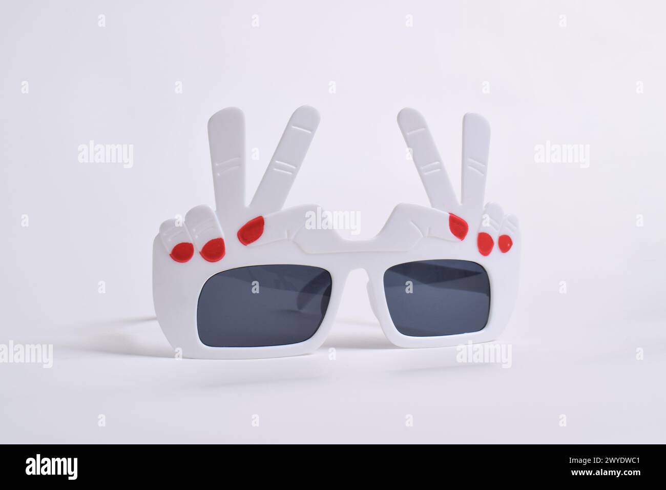 party or birthday glasses in the shape of scissor hands on a white ...