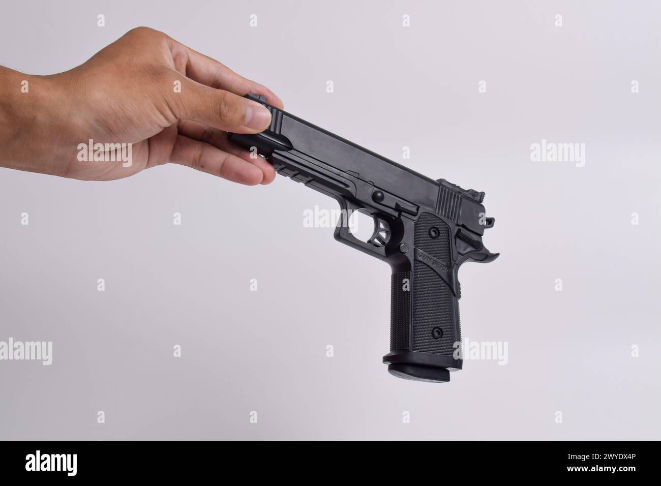 Mans hand holding gun hi-res stock photography and images - Alamy