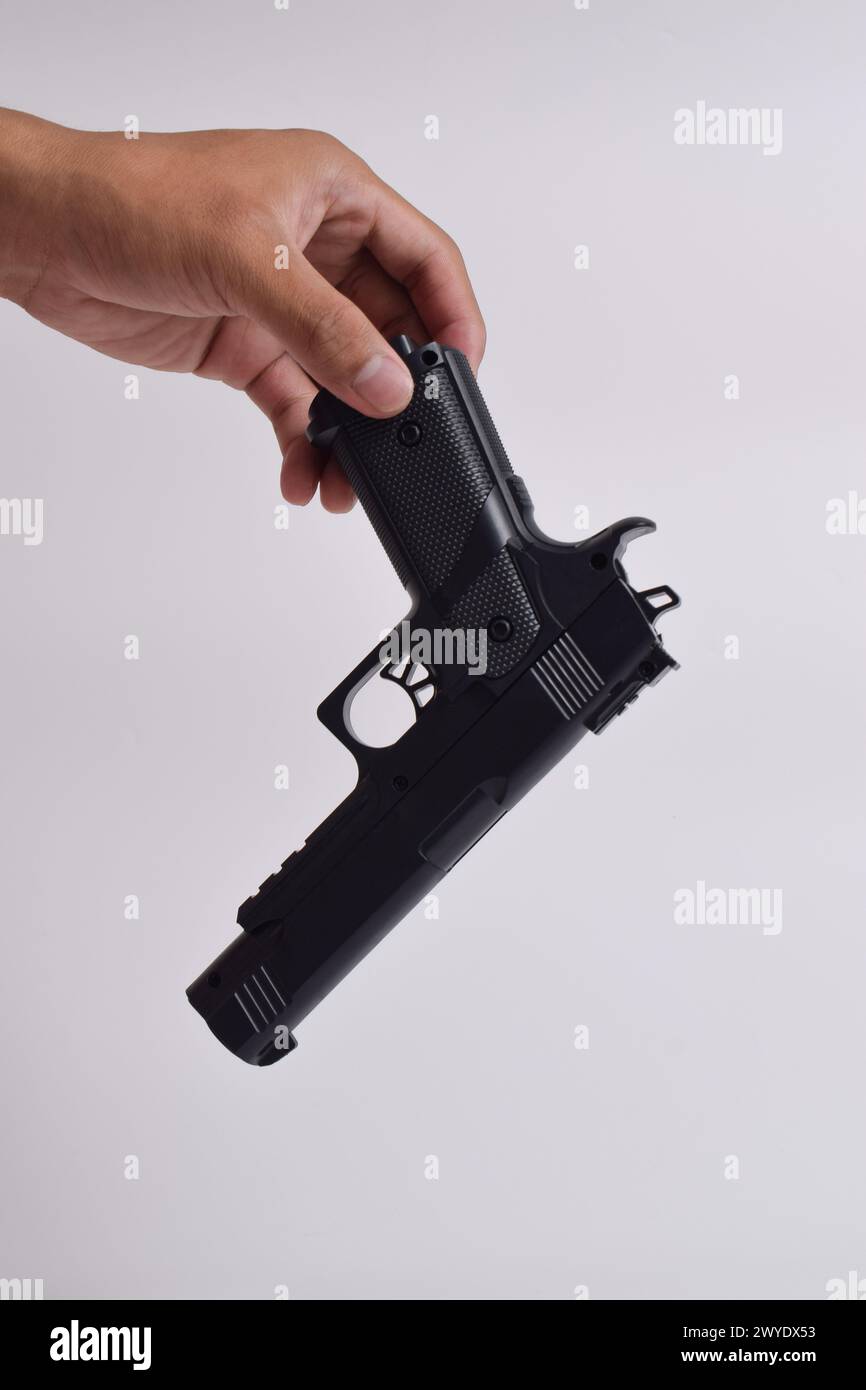 Male hand holding a gun on white background . A Pistol in a man's hand ...
