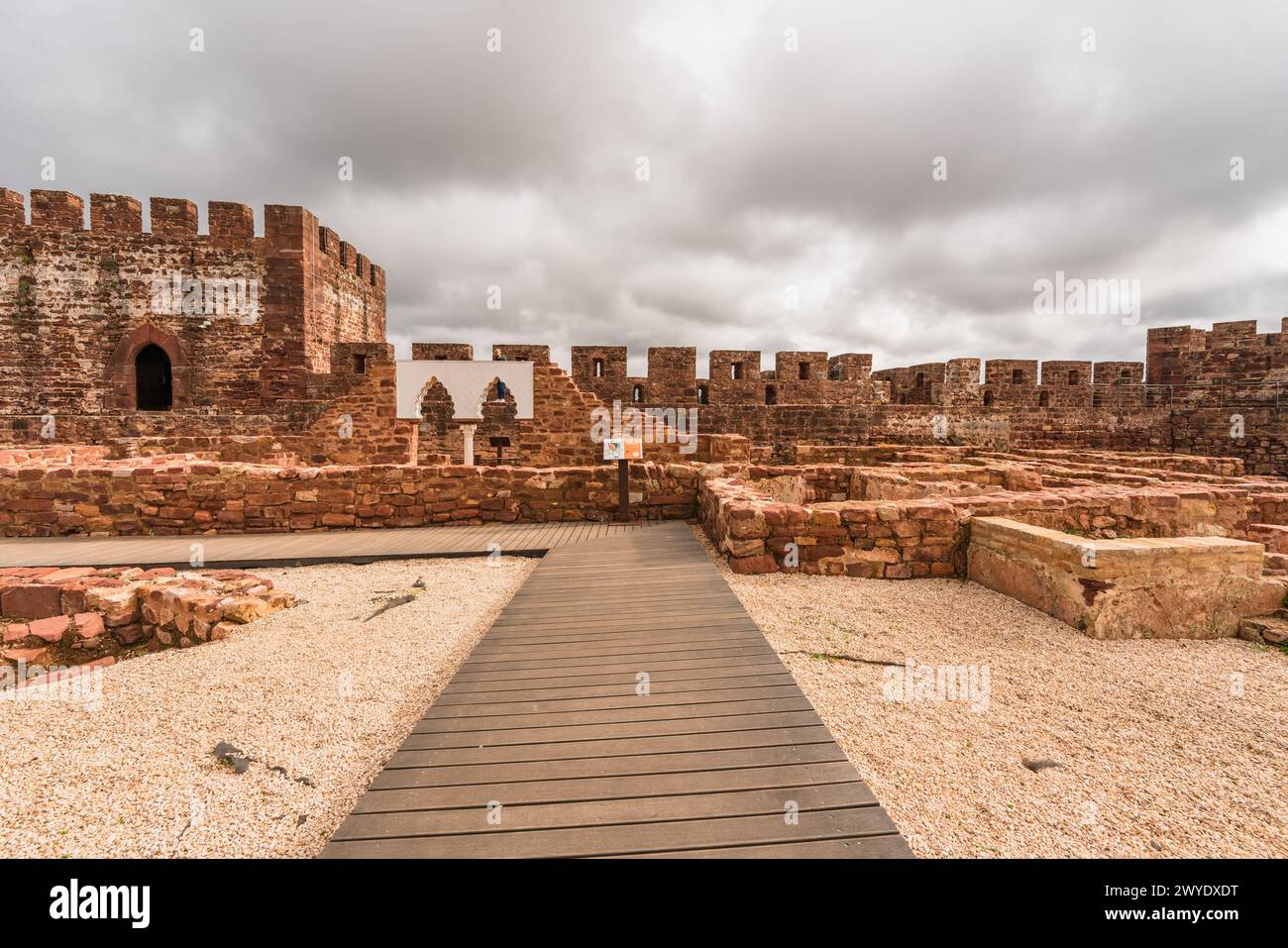 Wooden walkway leading through the ancient ruins within the walls of ...