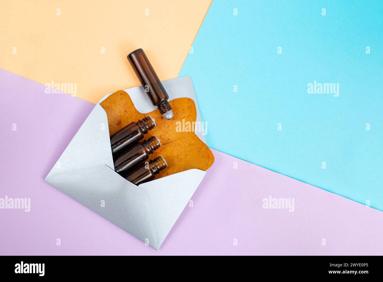 Many essential oil bottles and roll on in a silver envelope with a ...