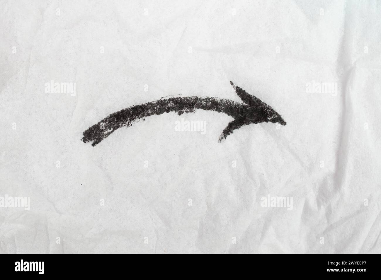 Arrow pointing downward to the right , scribbled with black ink on ...