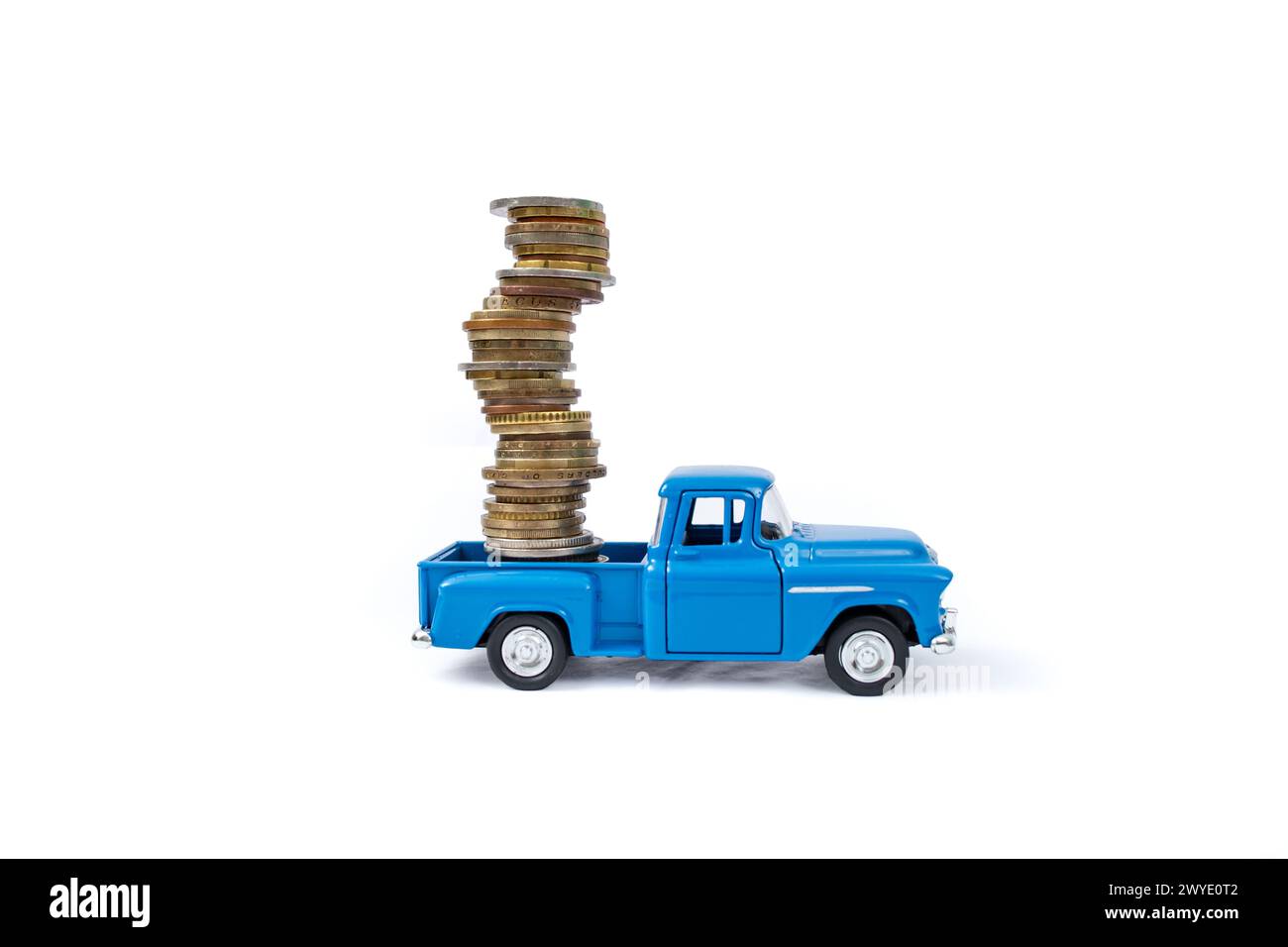 Die cast pickup toy carrying a high stack of coins, isolated on white ...