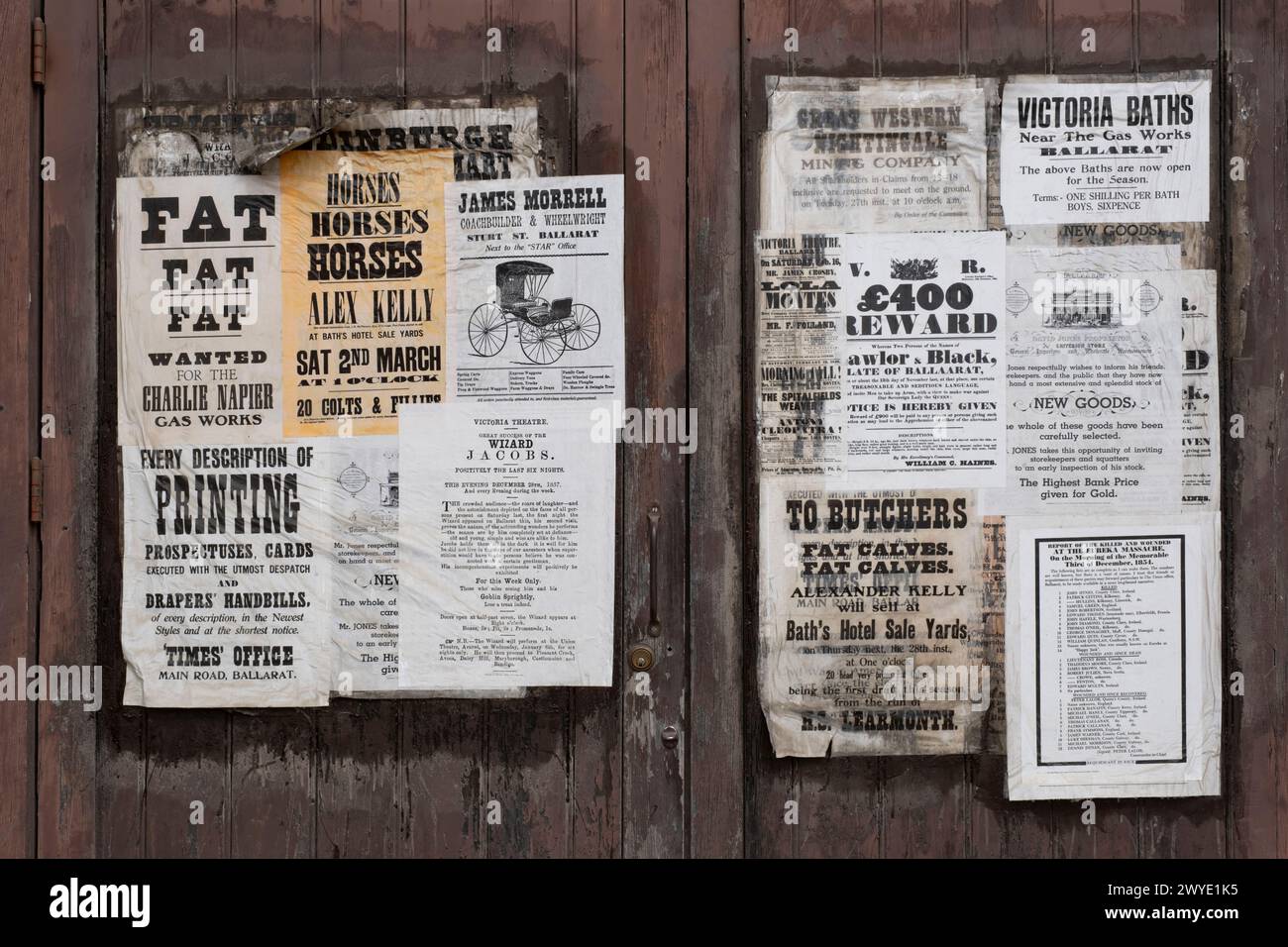 Old posters with advertisements, announcements and notices on a wooden ...