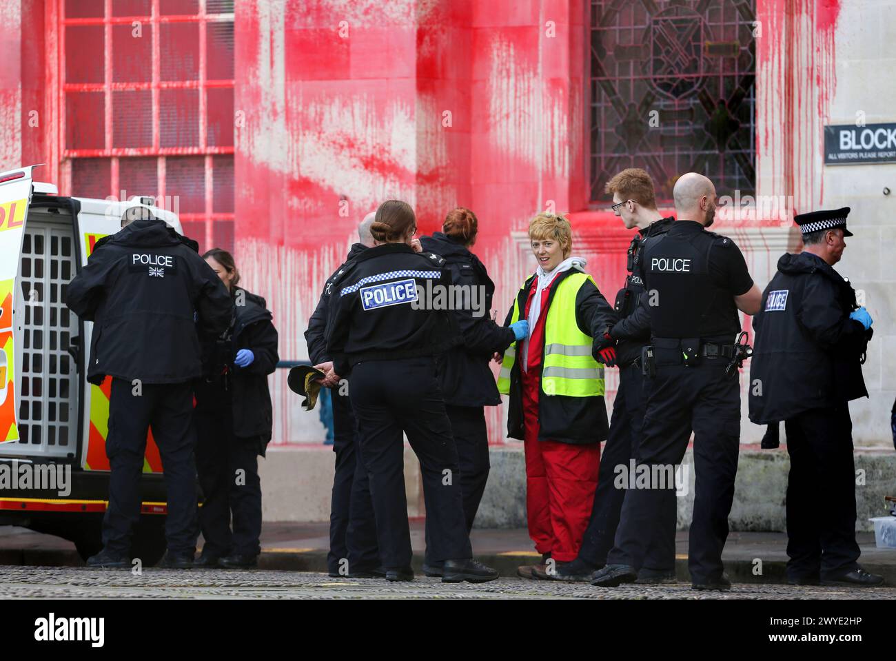 A protester is searched and arrested after being removed from a lock-on ...