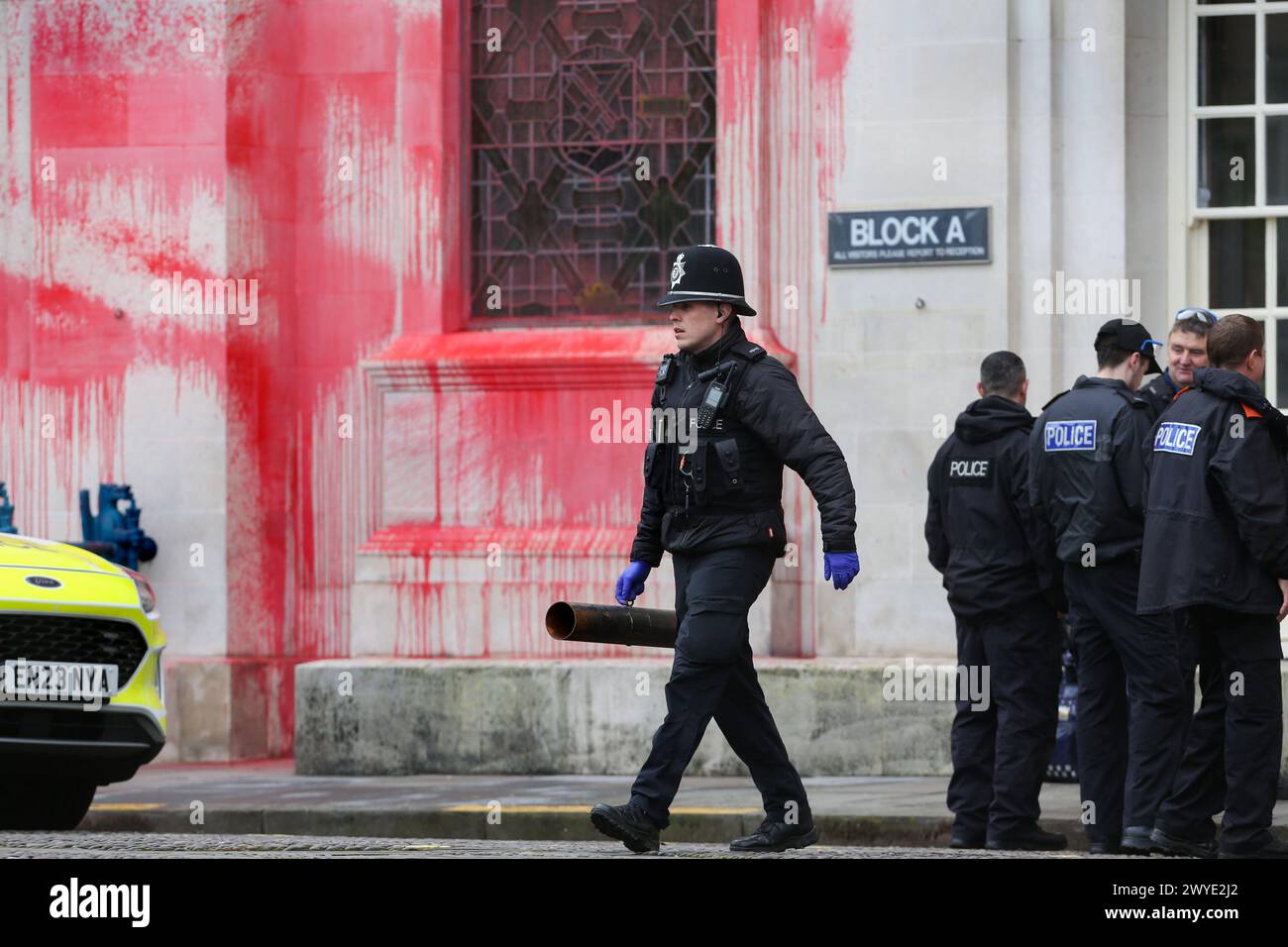 A police officer walks away with one of the protesterís lock-ons during ...