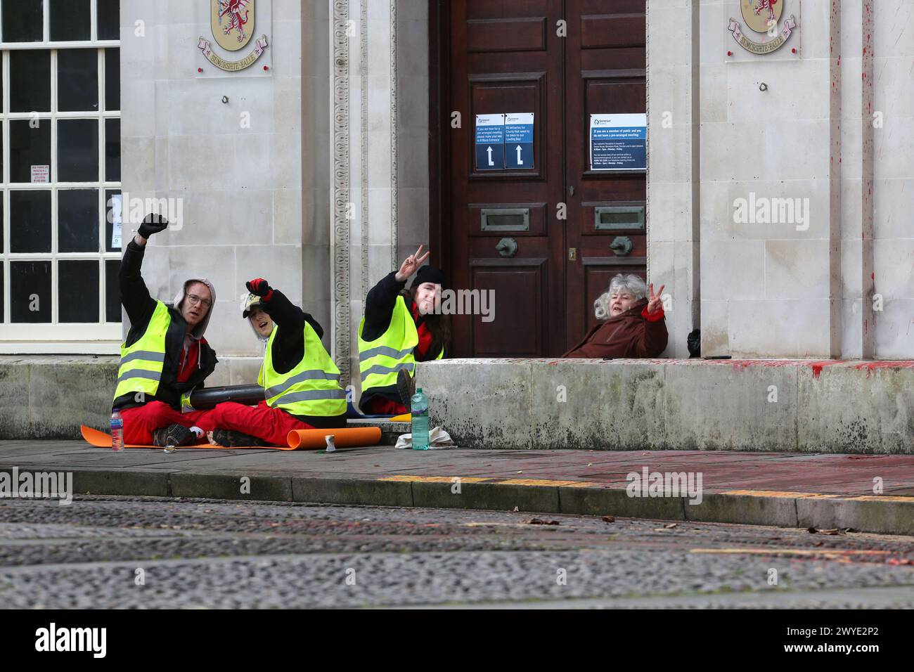 Supporters of Palestine Action in lock-ons raise their fists in the air ...
