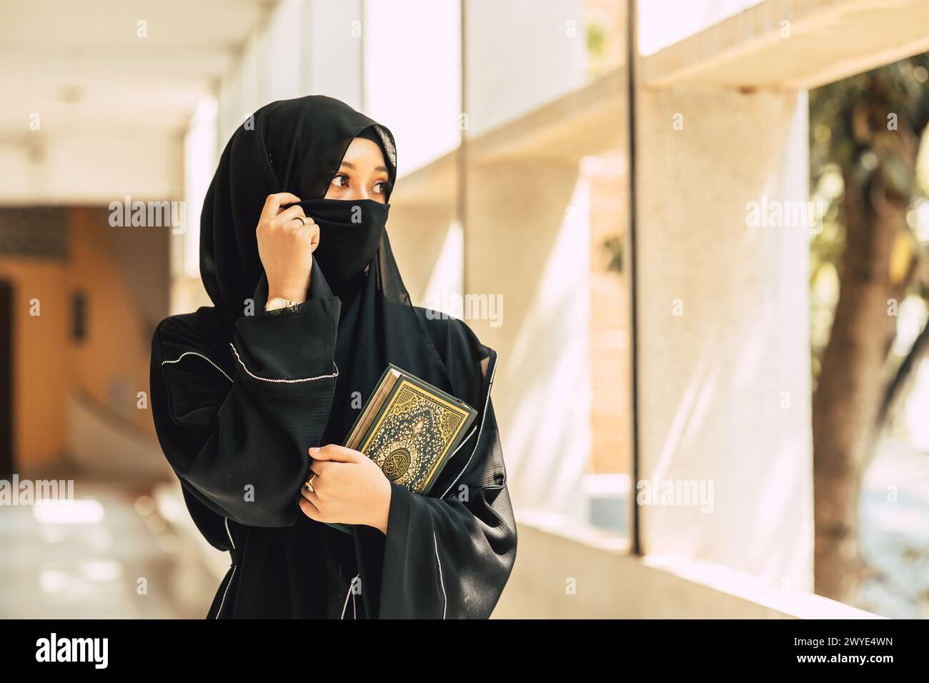 Young teen muslim niqab woman reading the Quran and faith The Holy Al ...