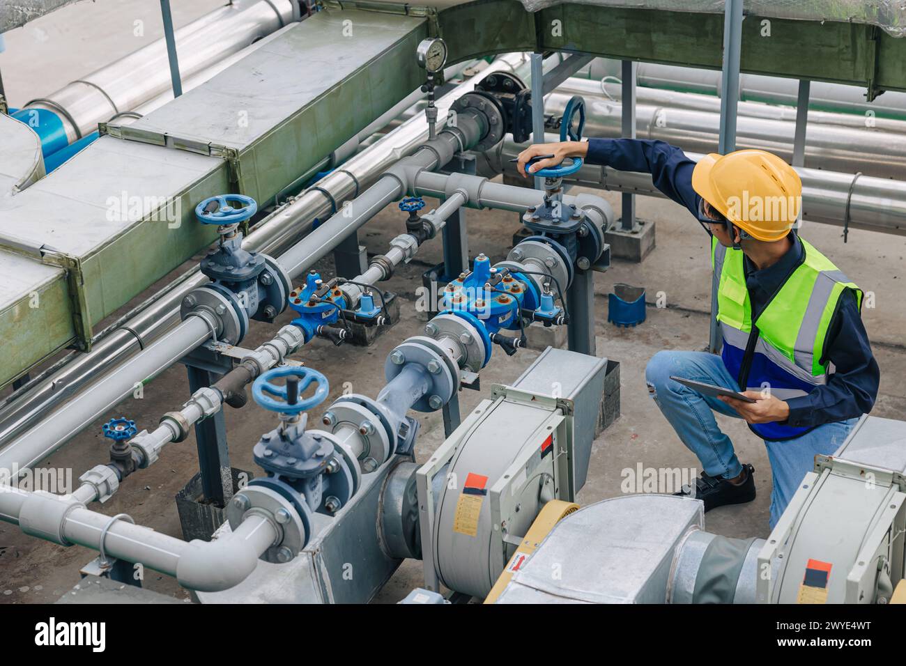 engineer male work checking water pipe inspecting valve testing water ...