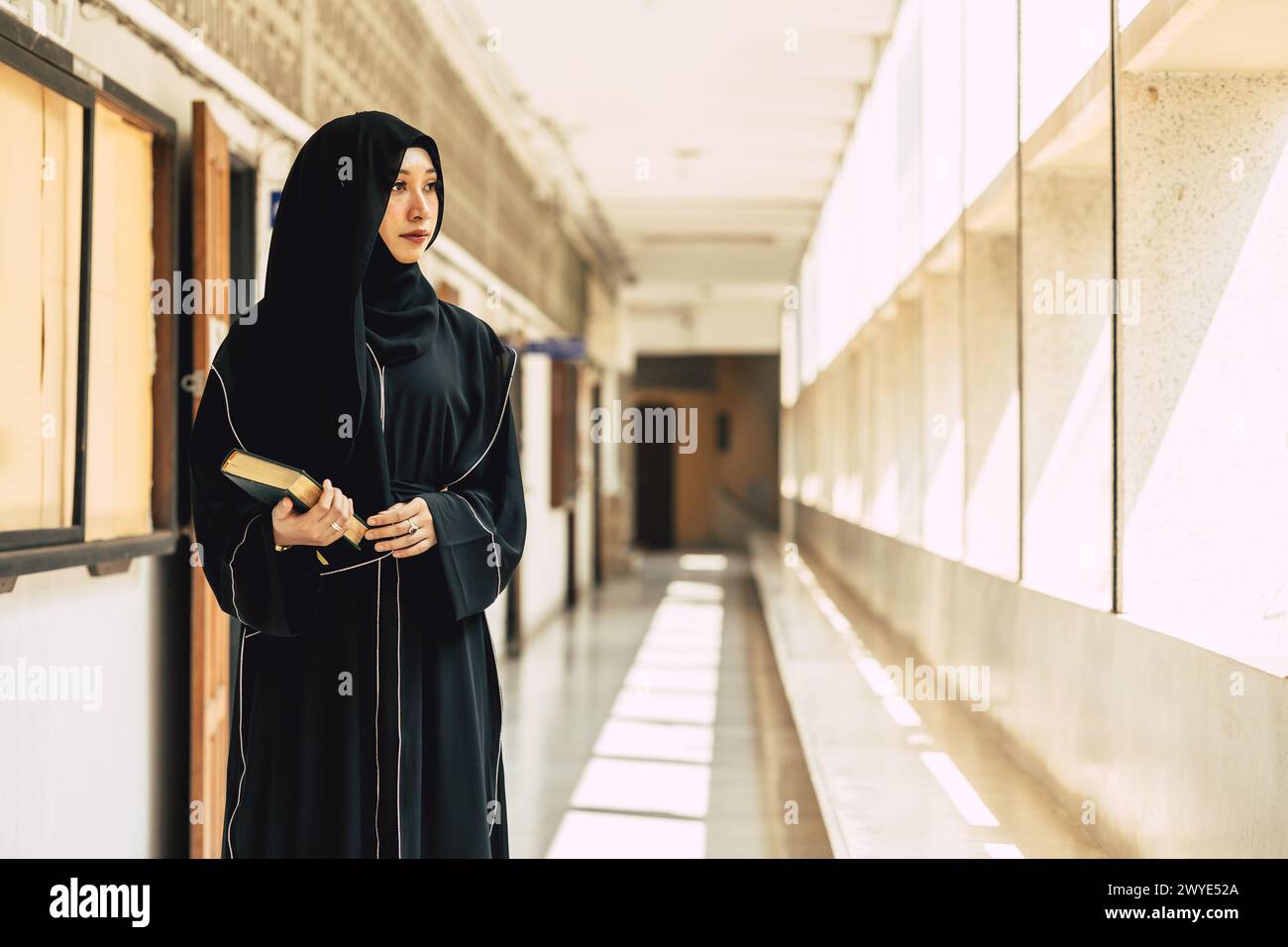 Young teen muslim niqab woman reading the Quran and faith The Holy Al ...