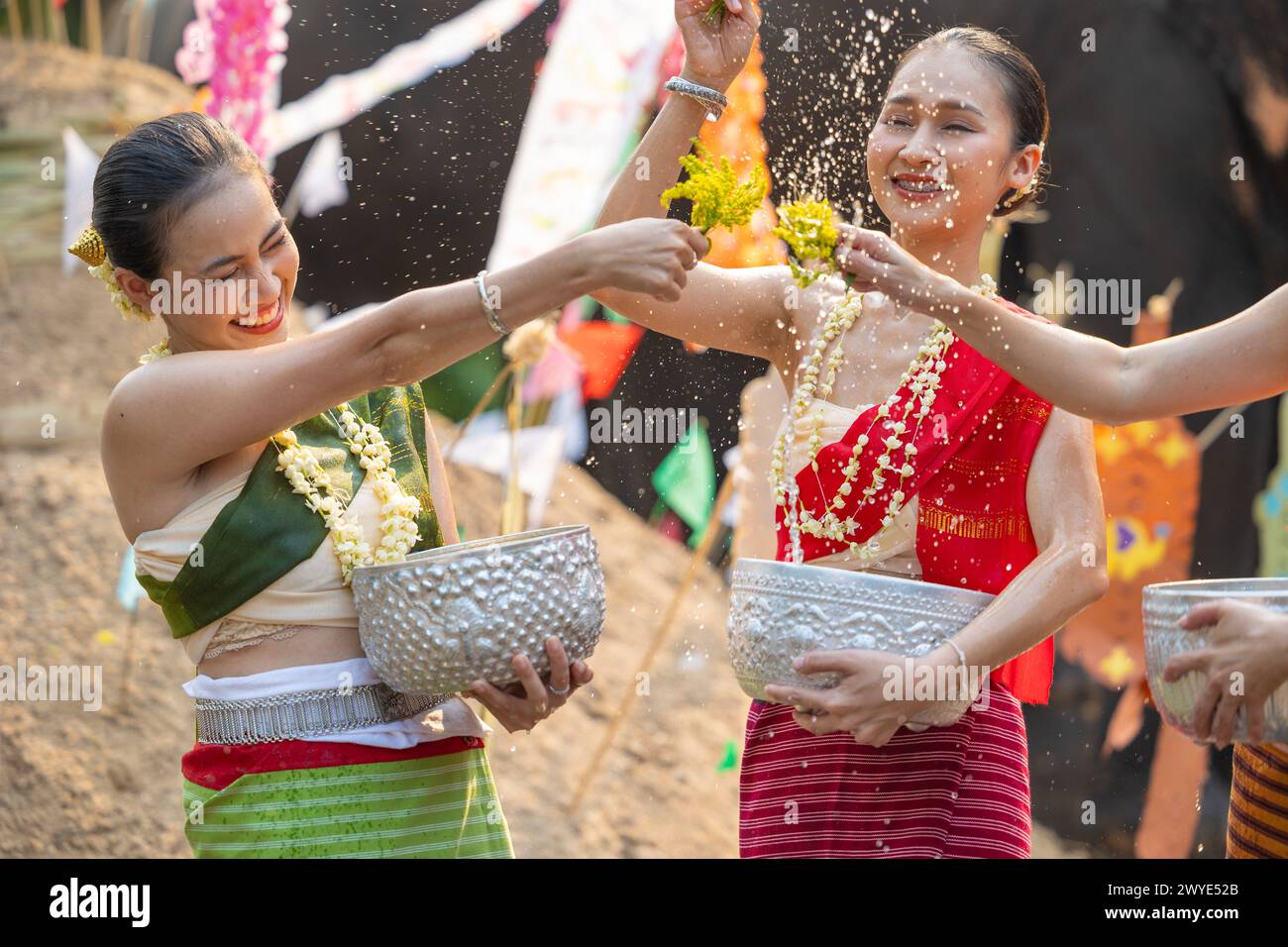 Songkran festival. Northern Thai people in Traditional clothes dressing splashing water together ...