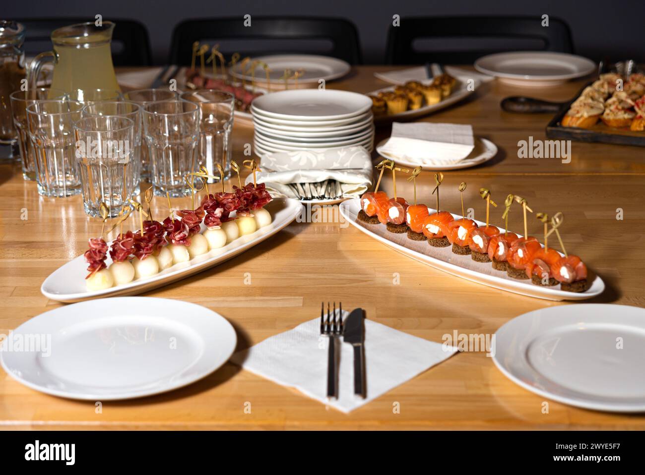 A banquet table elegantly set with an assortment of gourmet canapés ...