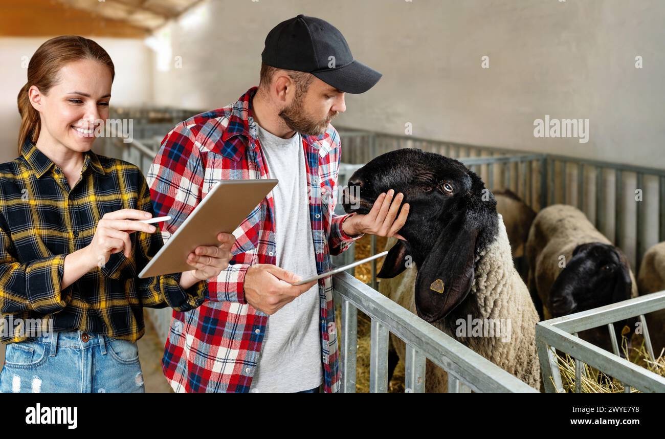 Young modern couple of farmers with digital tablets in hands work in ...