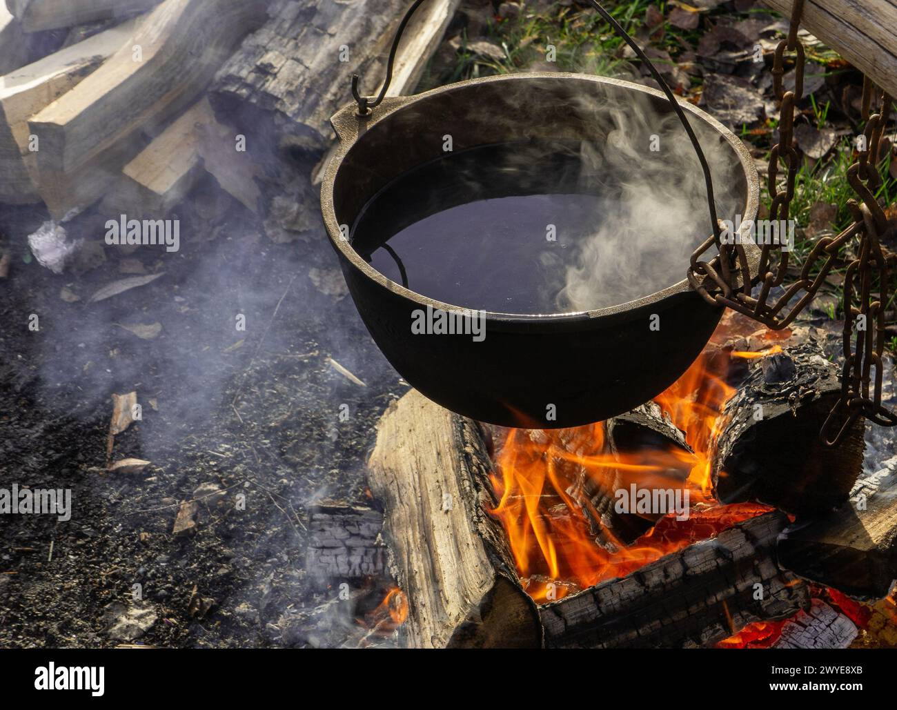 Pot On The Fire. Cauldron with liquid on fire from wood Stock Photo - Alamy