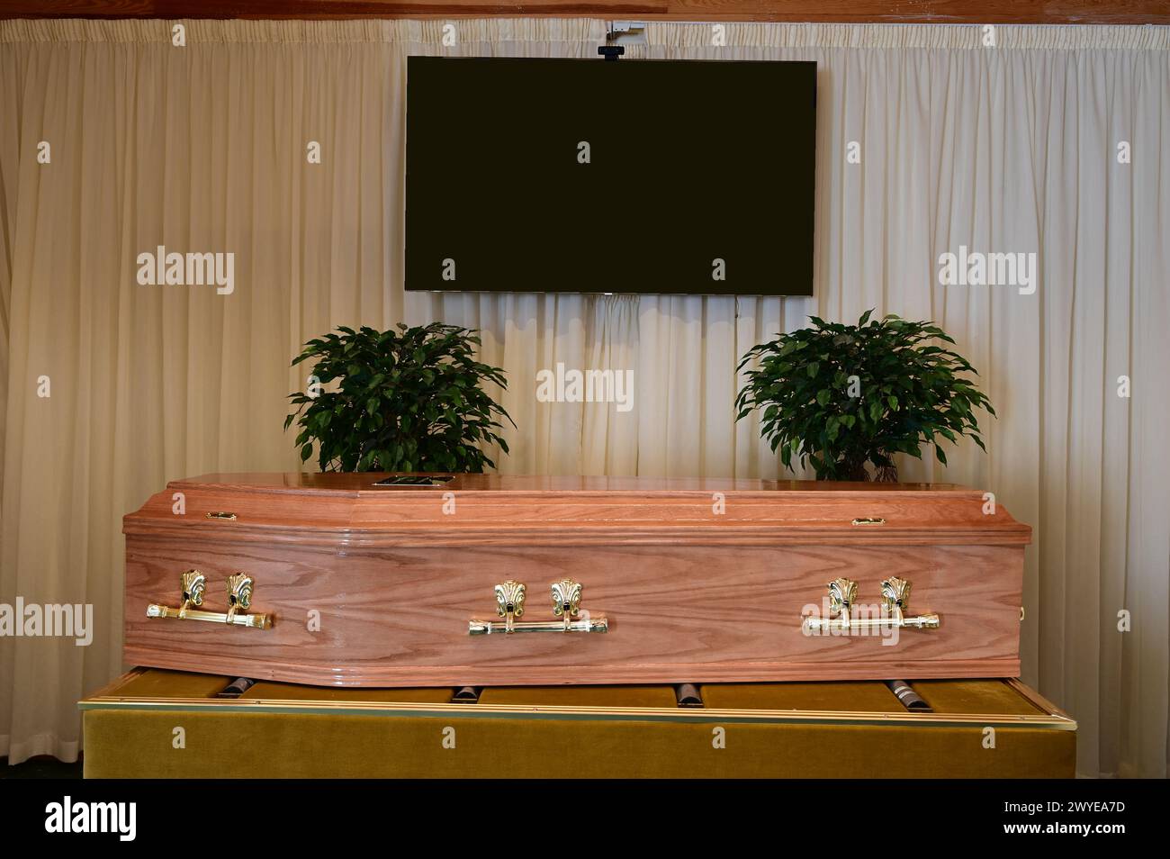 Coffin in a funeral chapel with the morning sun providing illumination ...