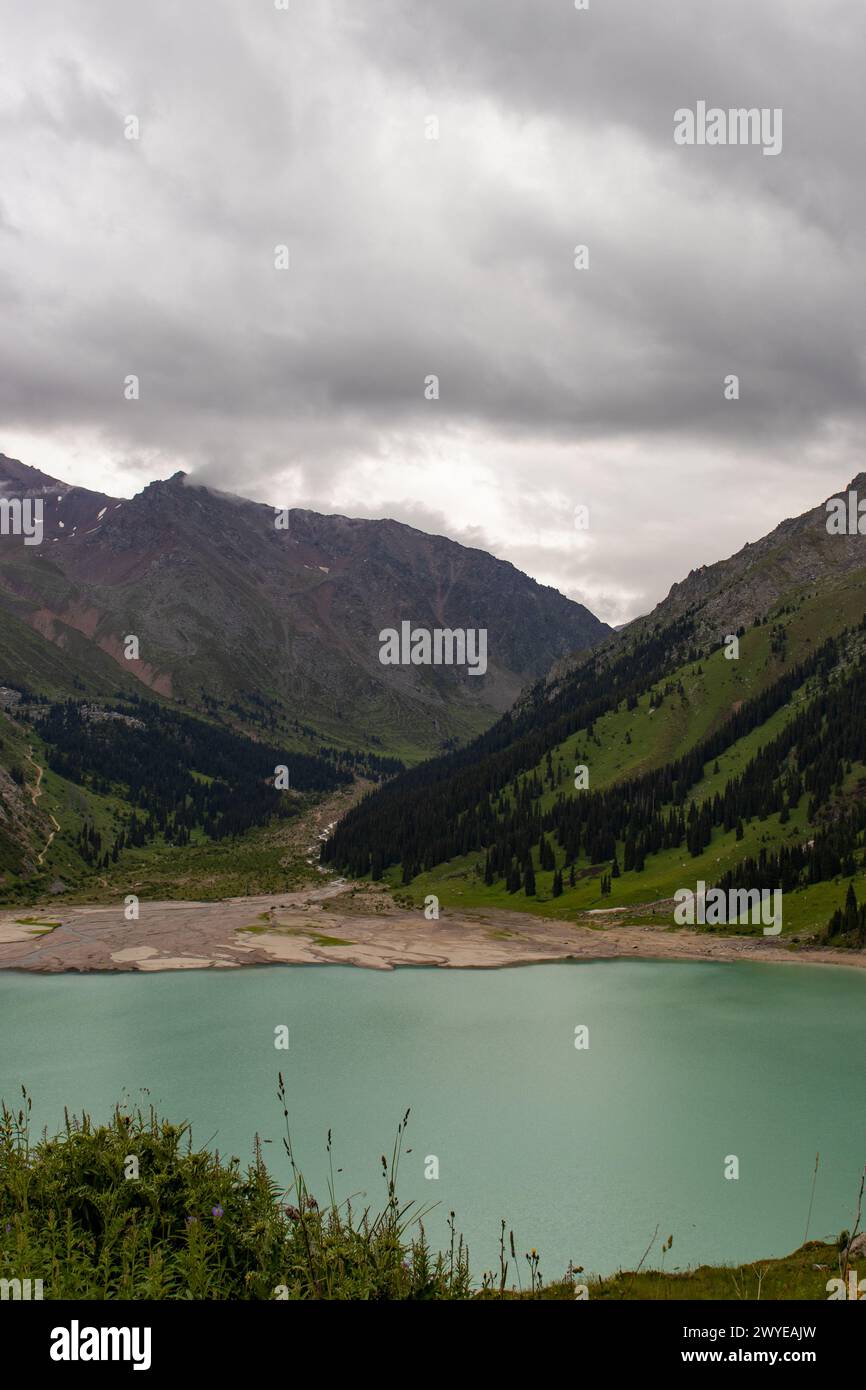 A lake in the middle of a valley surrounded by mountains Stock Photo ...