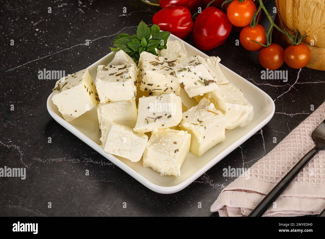 Greek traditional Feta cheese cubes with herbs and spices Stock Photo ...