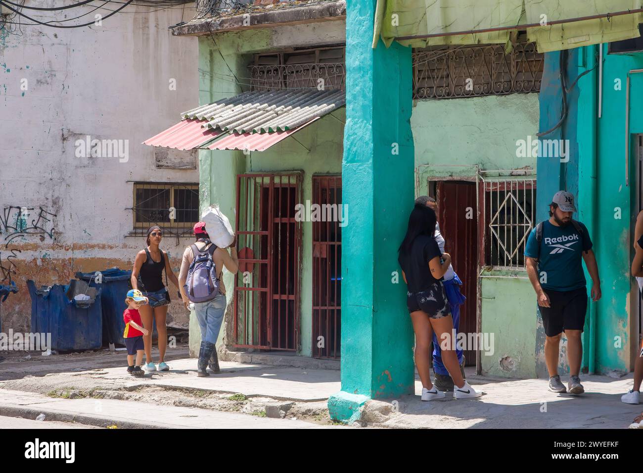 Cuban people lifestyle by buildings with metal grates in doors and ...
