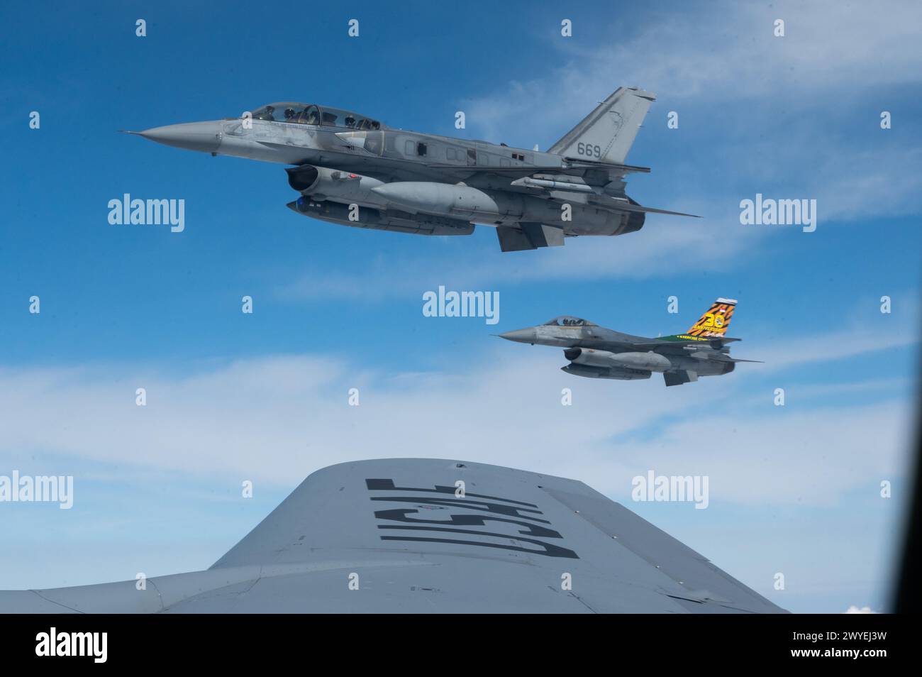 Two Republic of Singapore Air Force F-16s fly alongside a Washington ...
