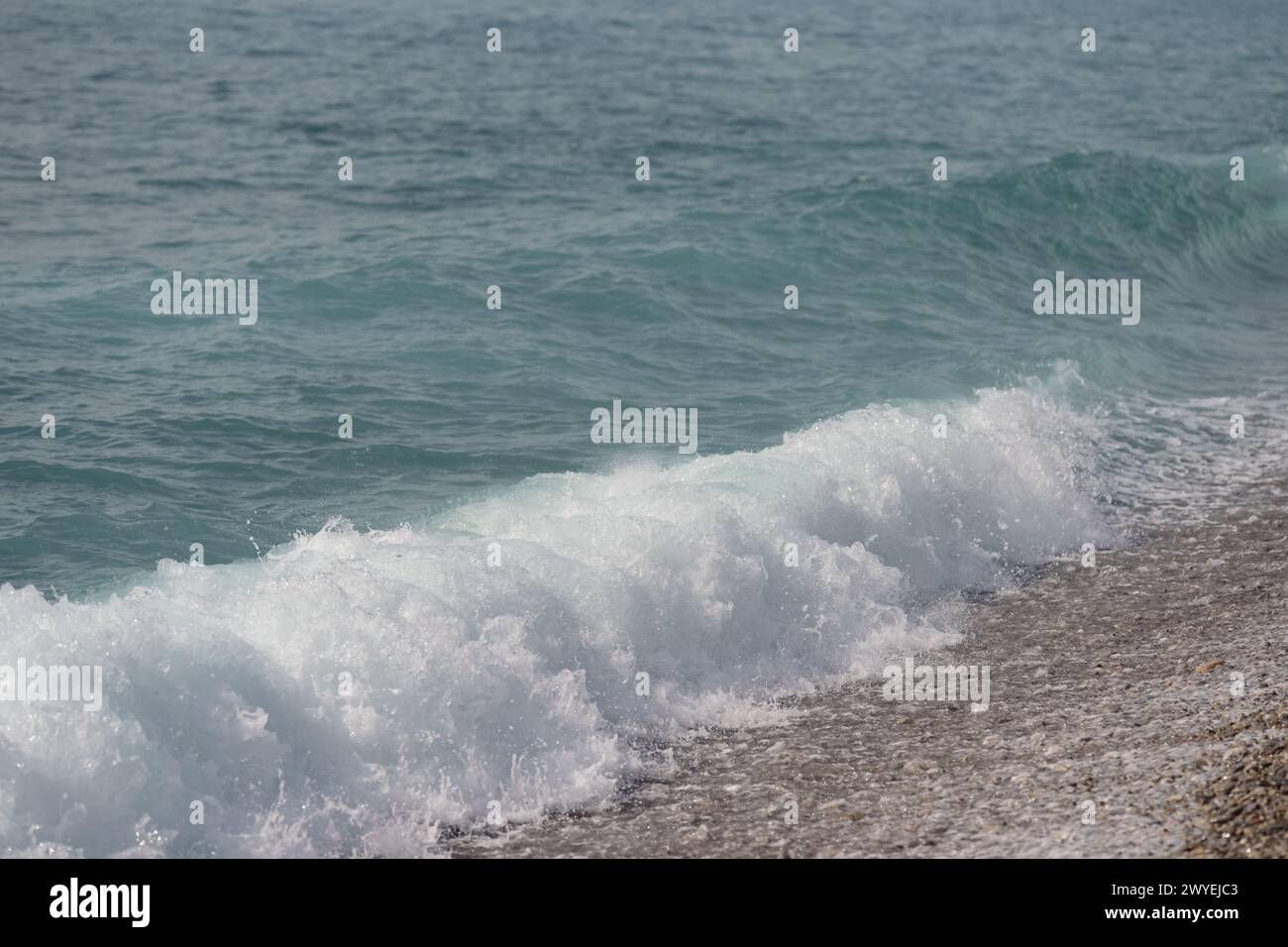 Pebble beach with nice clean sea waves, travel content Stock Photo - Alamy