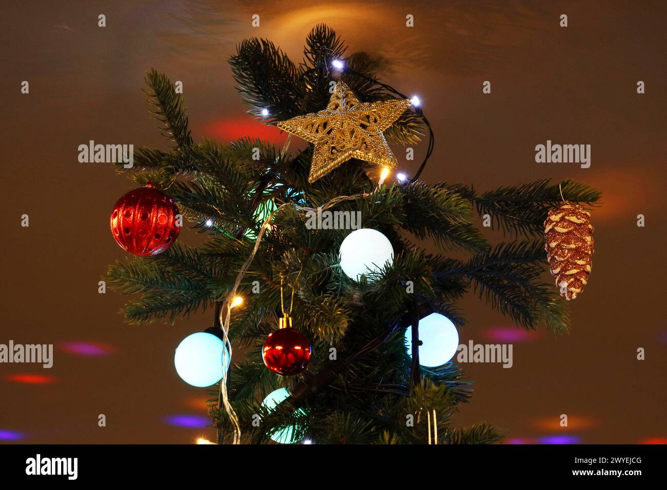 Indoor Christmas tree decorated with balls, stars, garlands, pine cones ...